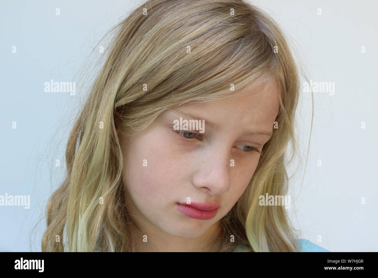 Portrait of a sad preteen girl looking down Stock Photo - Alamy Portrait of a sad preteen girl looking down Stock Photo - Alamy