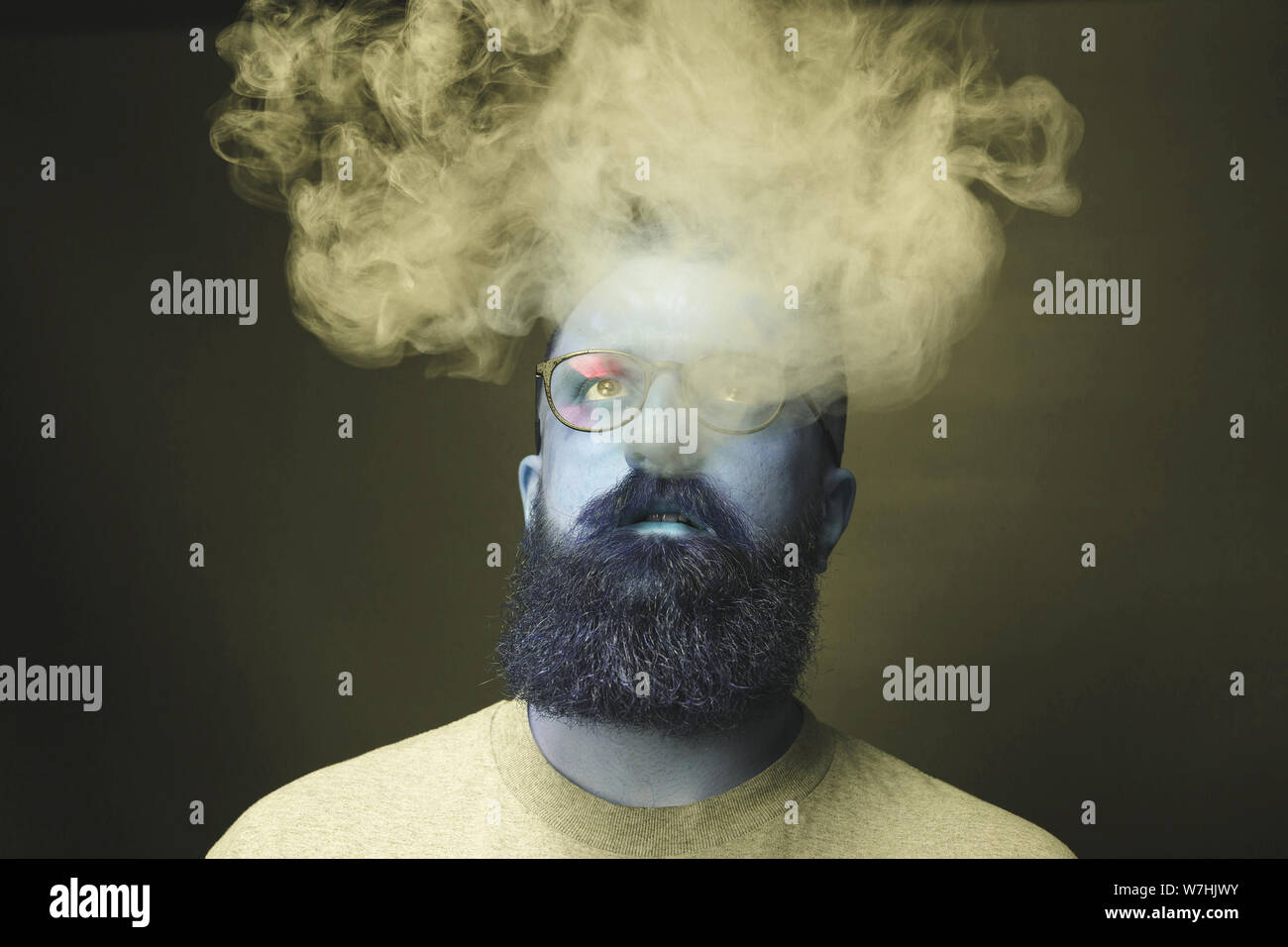 Concept. Smoke enveloped the head man. Portrait of a Bearded, stylish ...