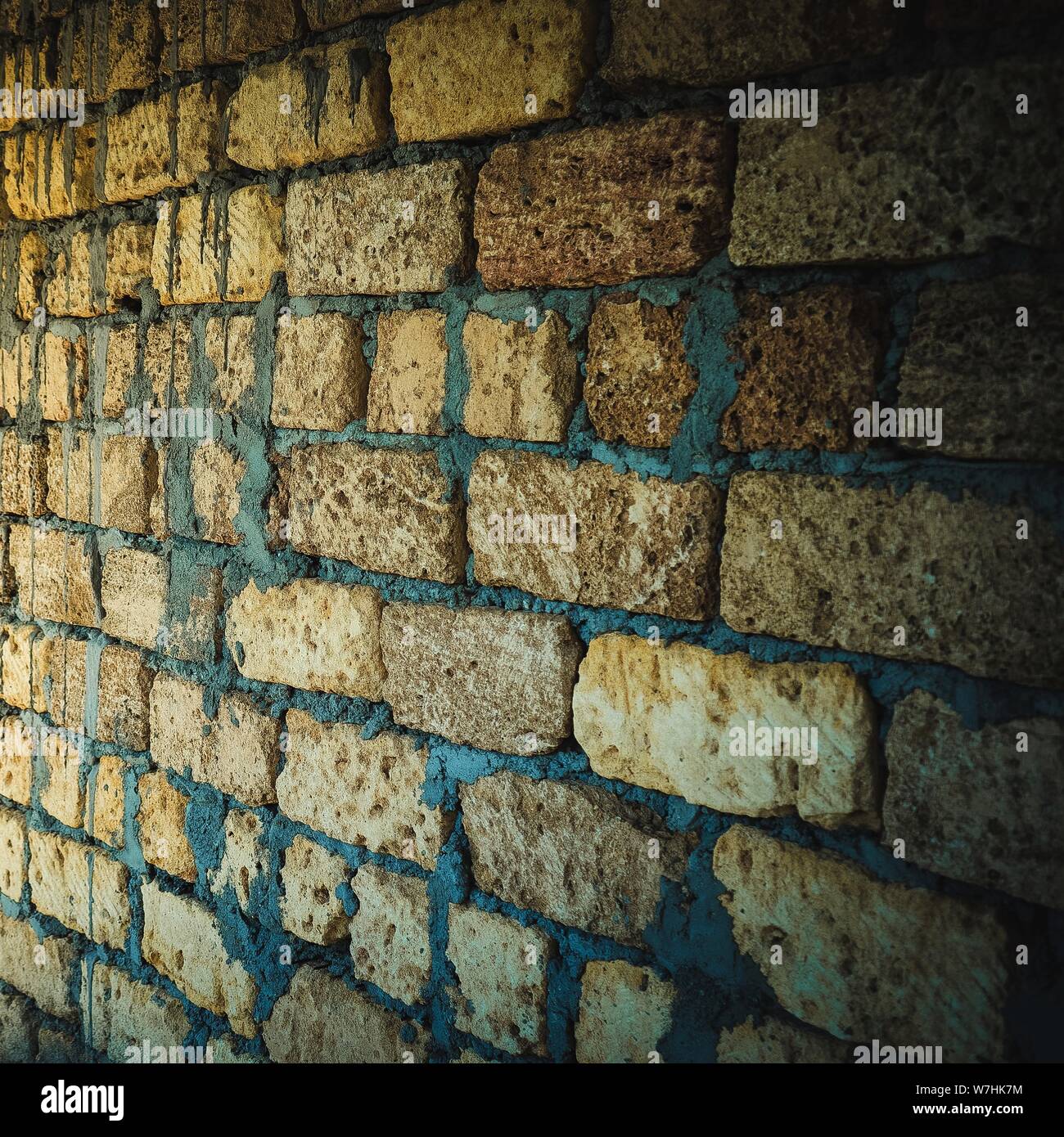 old wall of yellow limestone with grey seams, perspective view Stock ...