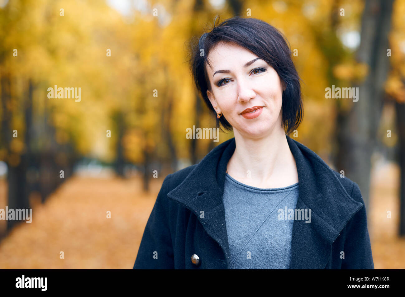 Beautiful woman posing in autumn city park, fall season, yellow leaves Stock Photo - Alamy