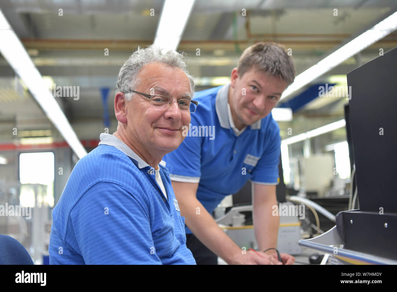 teamwork in a modern industrial factory - group of workers in the ...