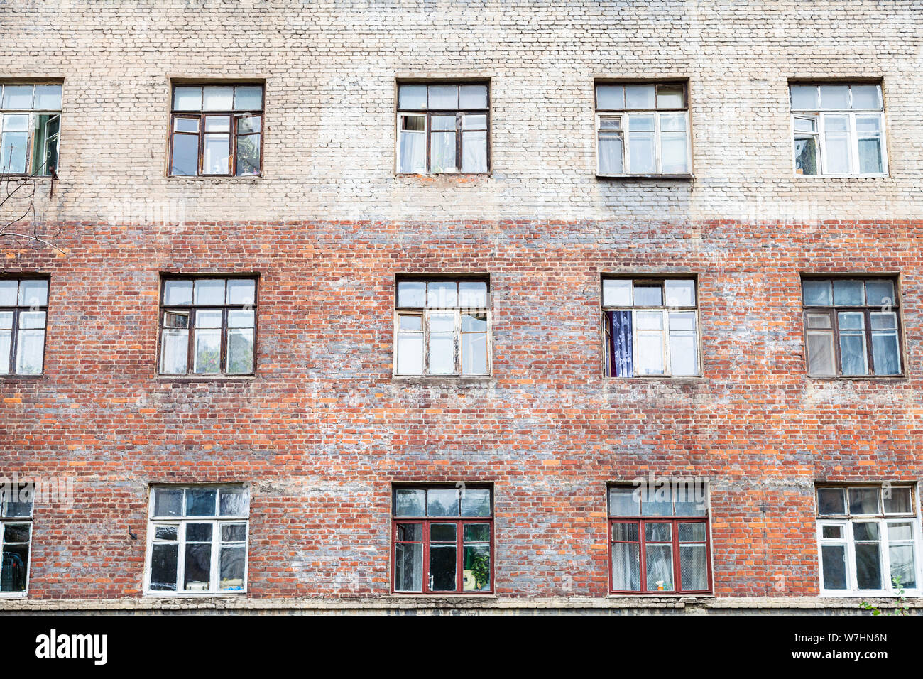 facade of shabby wall of old multistorey brick house in Moscow city ...