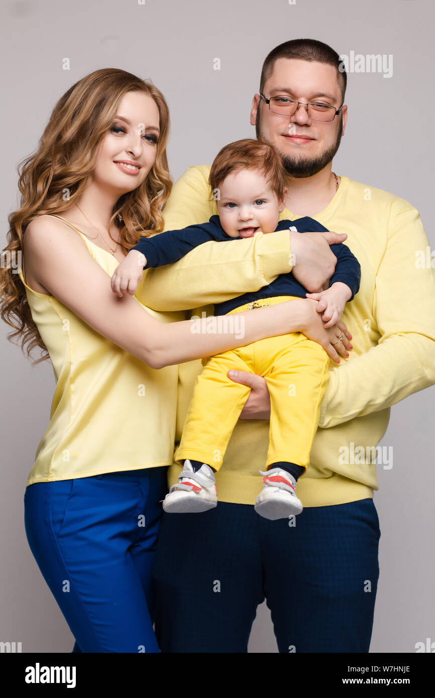 Family in yellow outfit posing on isolated background Stock Photo - Alamy