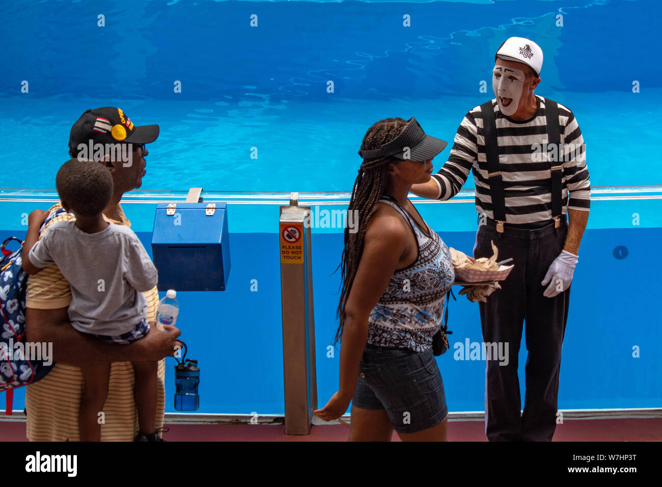 Orlando, Florida. July 26, 2019 Mime artist interacting with people ...