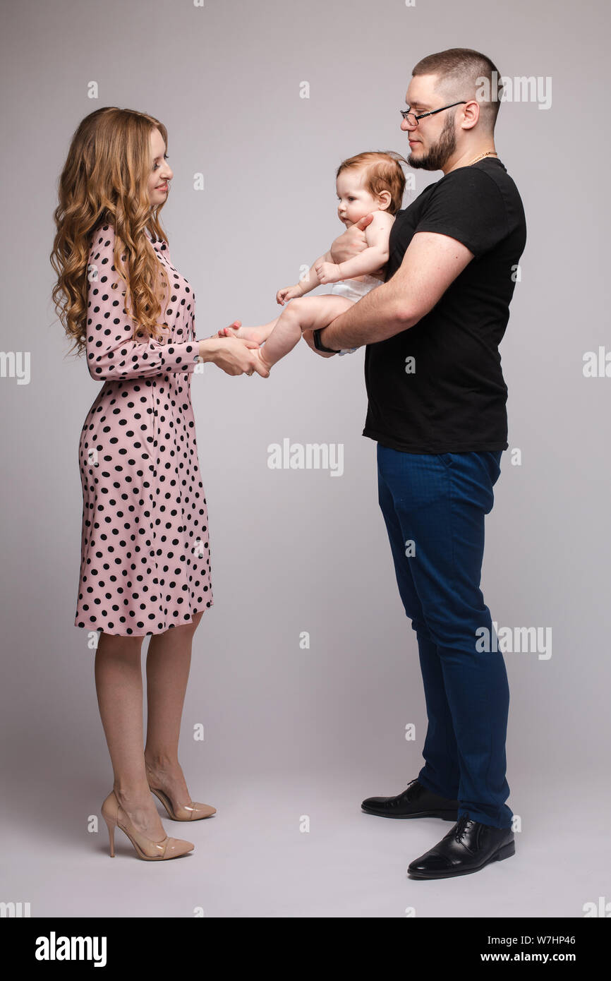 Portrait of happy family from three people posing at camera Stock Photo ...
