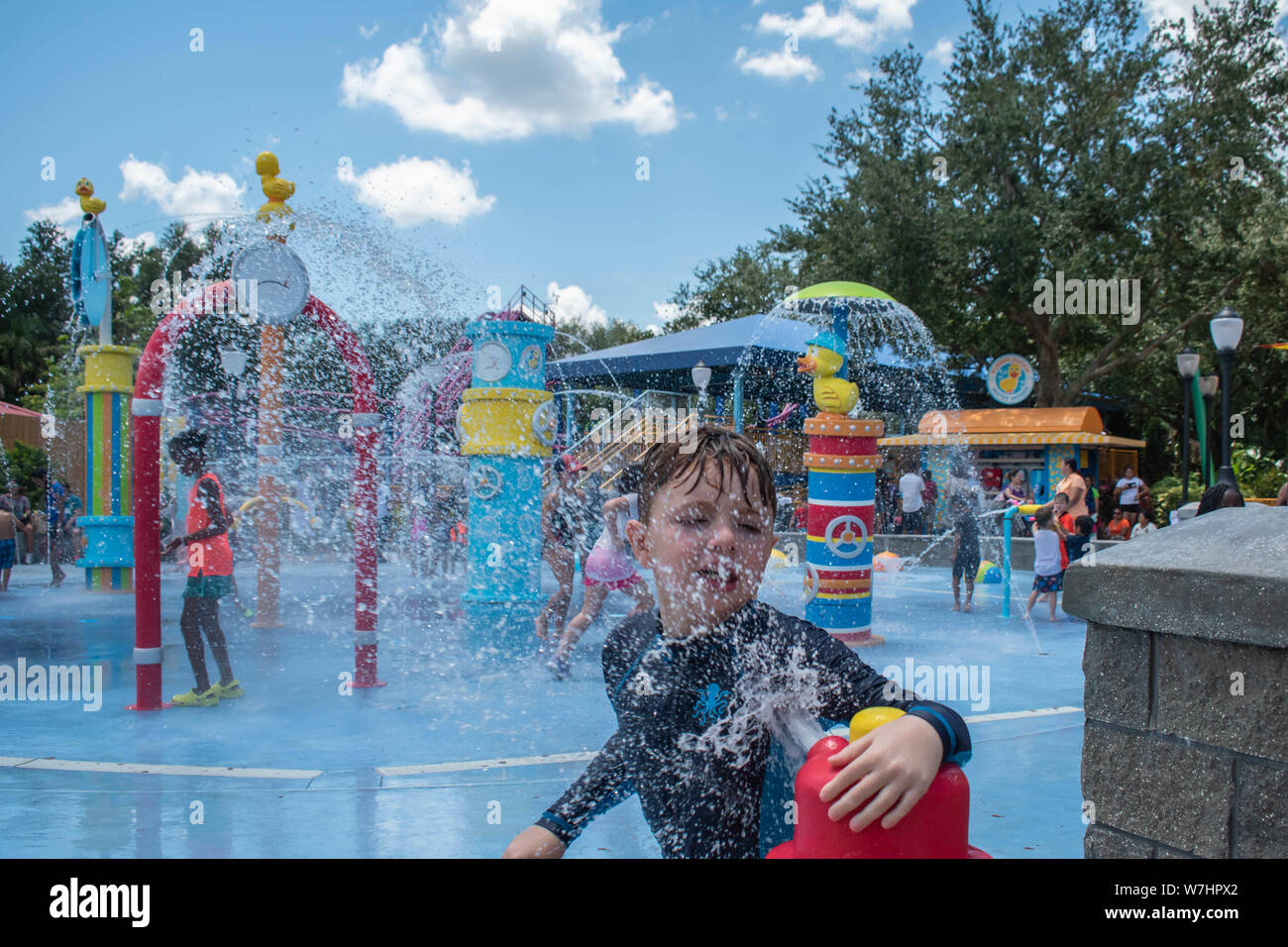 Orlando, Florida. July 30, 2019. Nice boy playing with the water jet in ...