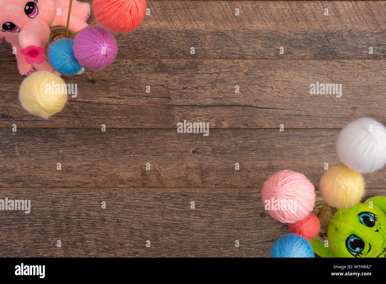 Baby plush toys with colorful yarn balls Stock Photo - Alamy