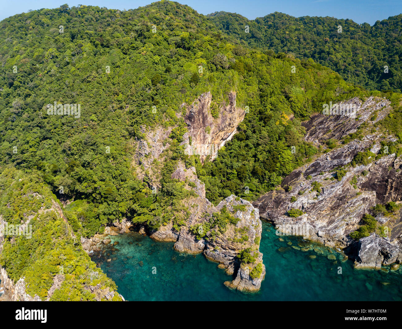 Aerial drone view of a beautiful tropical island with sheer, vertical ...