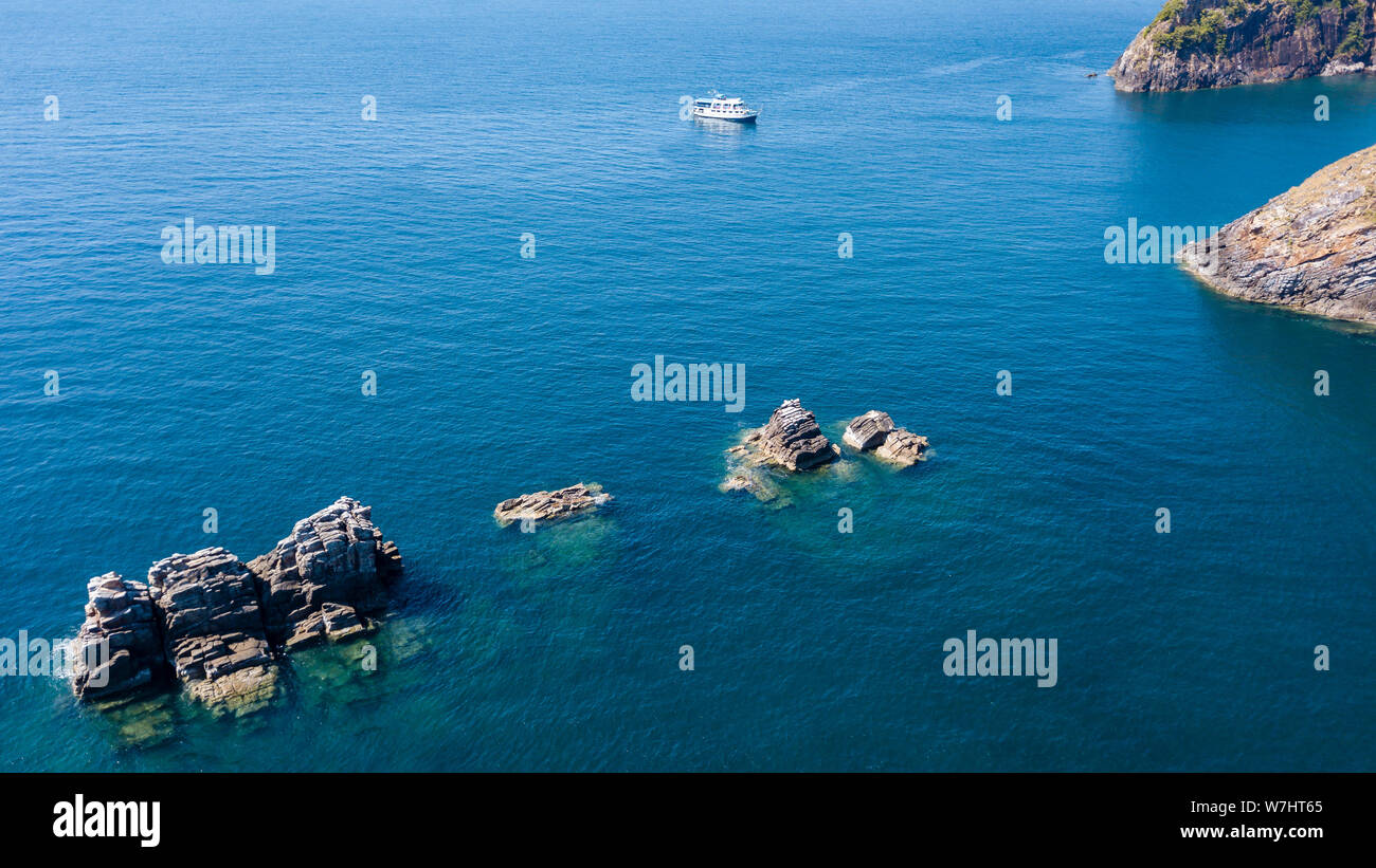 A SCUBA diving boat moored off a beautiful tropical island in the ...