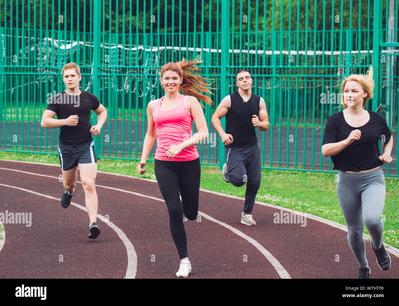 Professional runners running on a race track Stock Photo - Alamy