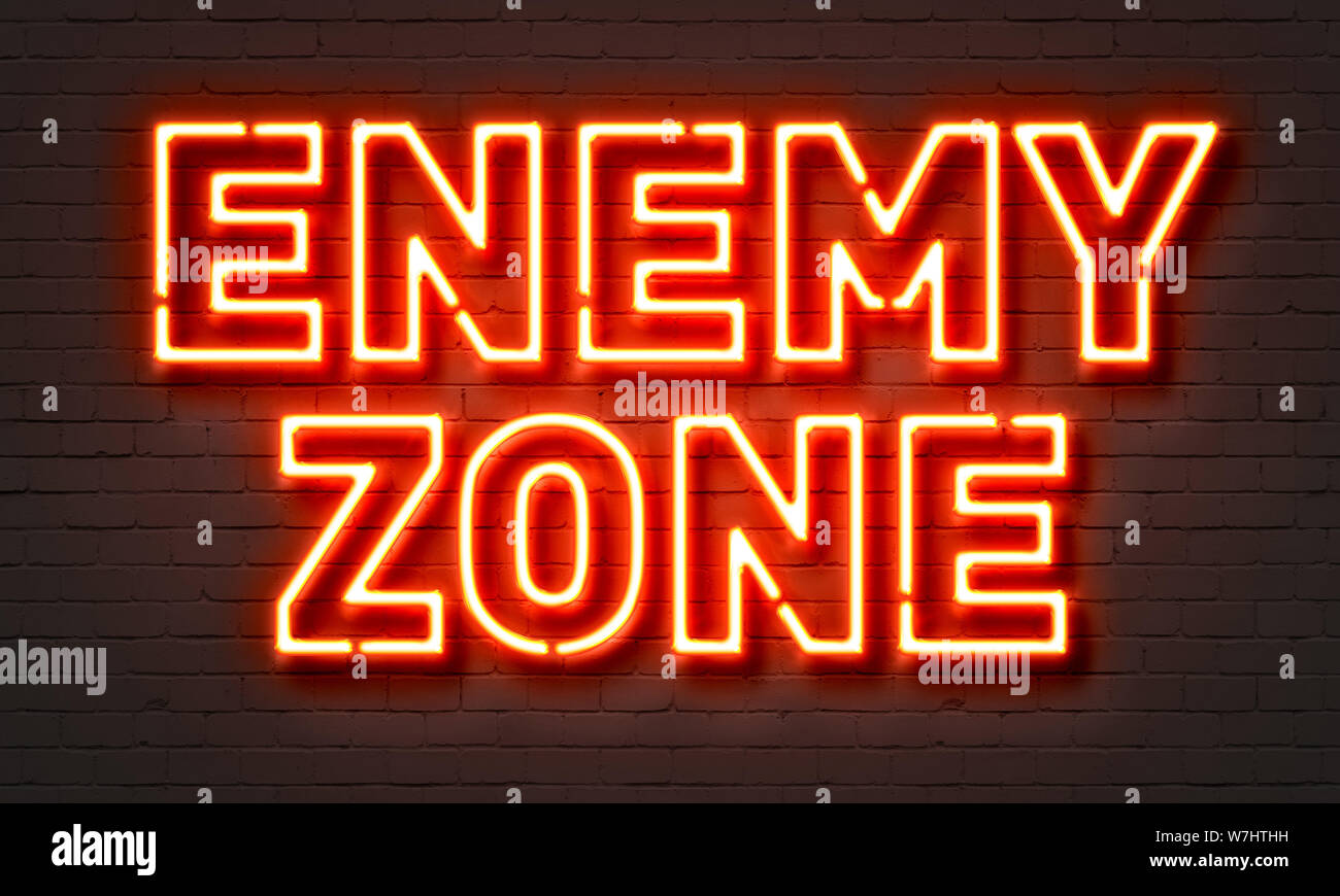 Enemy zone neon sign on brick wall background Stock Photo - Alamy