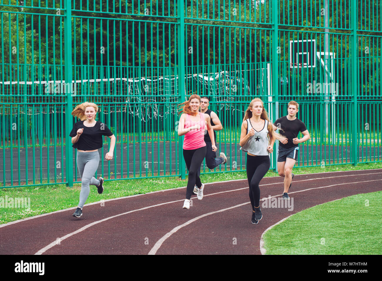 Professional runners running on a race track Stock Photo - Alamy