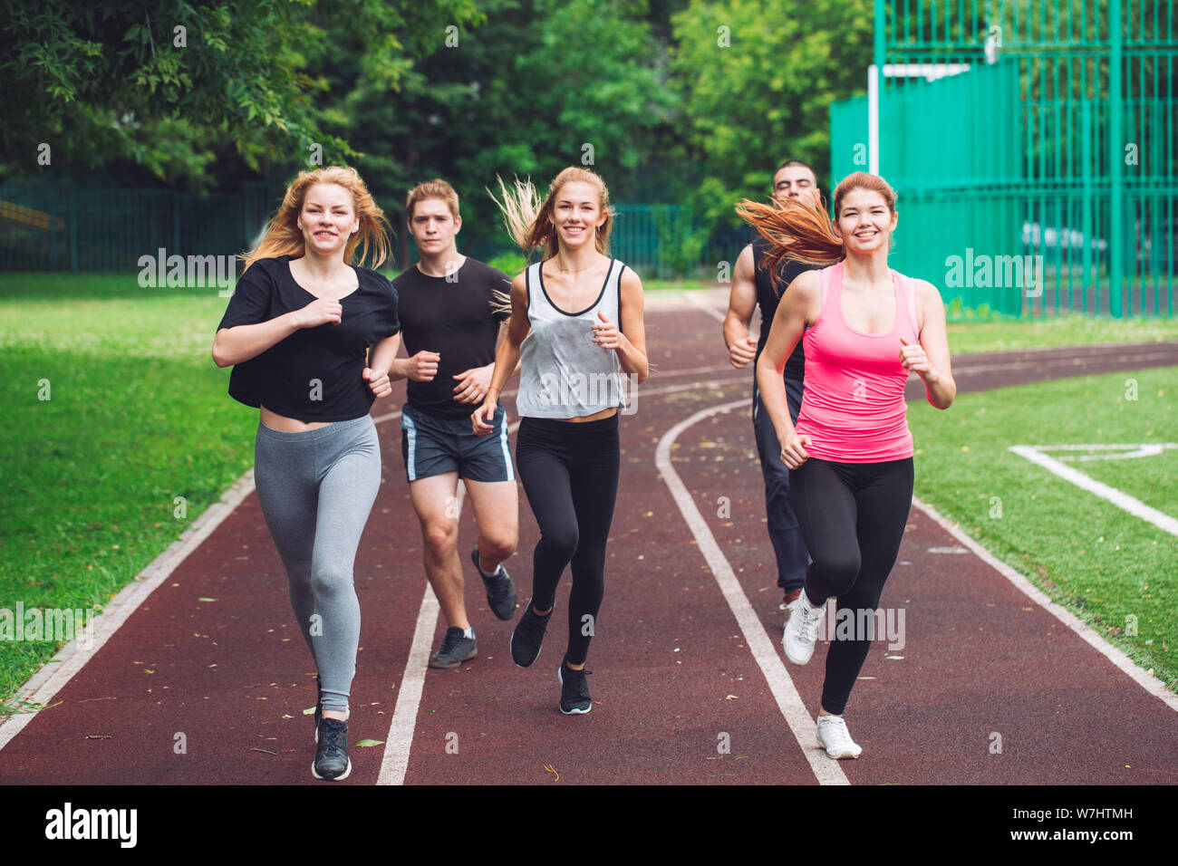 Professional runners running on a race track Stock Photo - Alamy