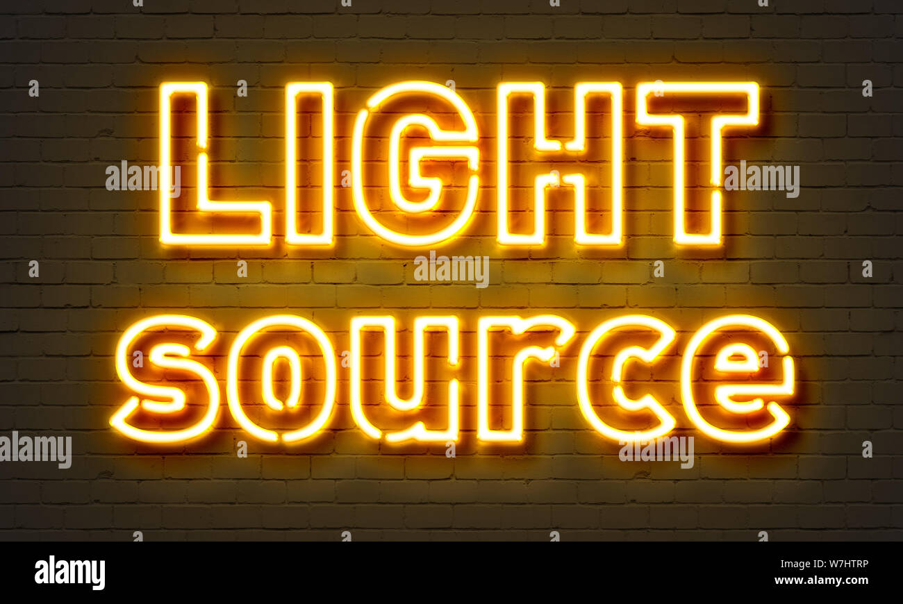 Light source neon sign on brick wall background Stock Photo - Alamy