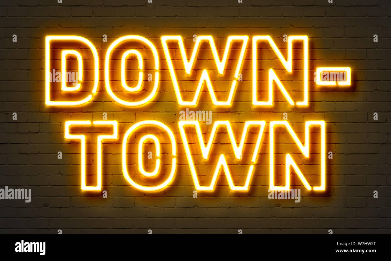 Downtown neon sign on brick wall background Stock Photo - Alamy