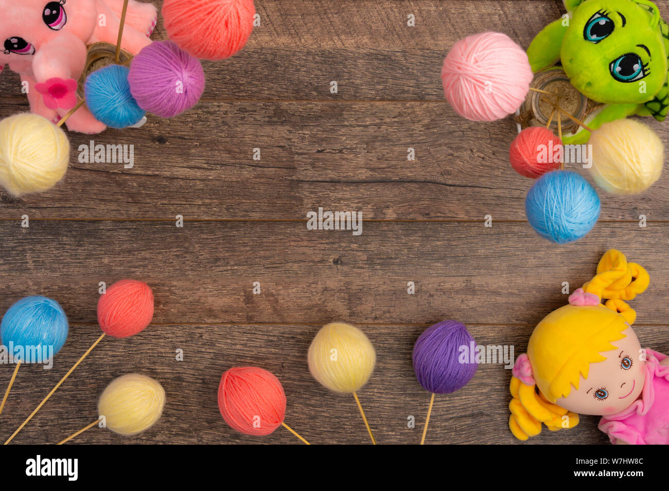 Plush baby toys and yarn balls, with copy space Stock Photo - Alamy