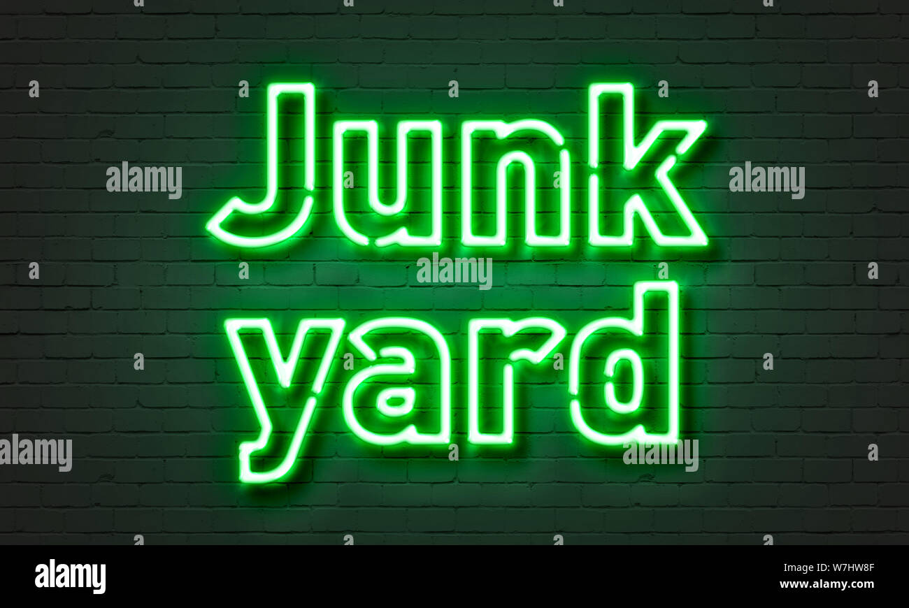 Junk yard neon sign on brick wall background Stock Photo - Alamy