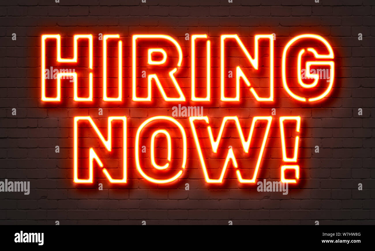 Hiring now neon sign on brick wall background Stock Photo - Alamy