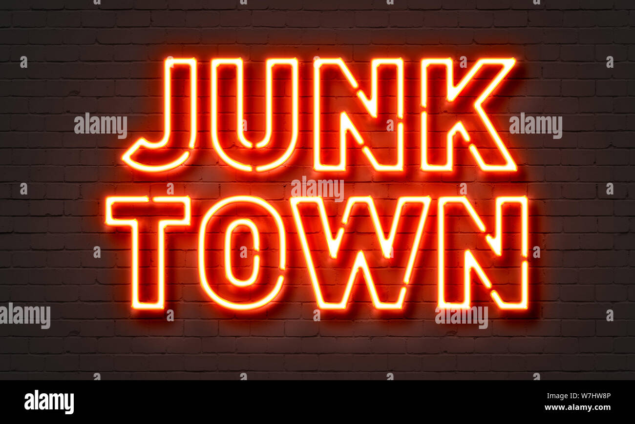 Junk town neon sign on brick wall background Stock Photo - Alamy