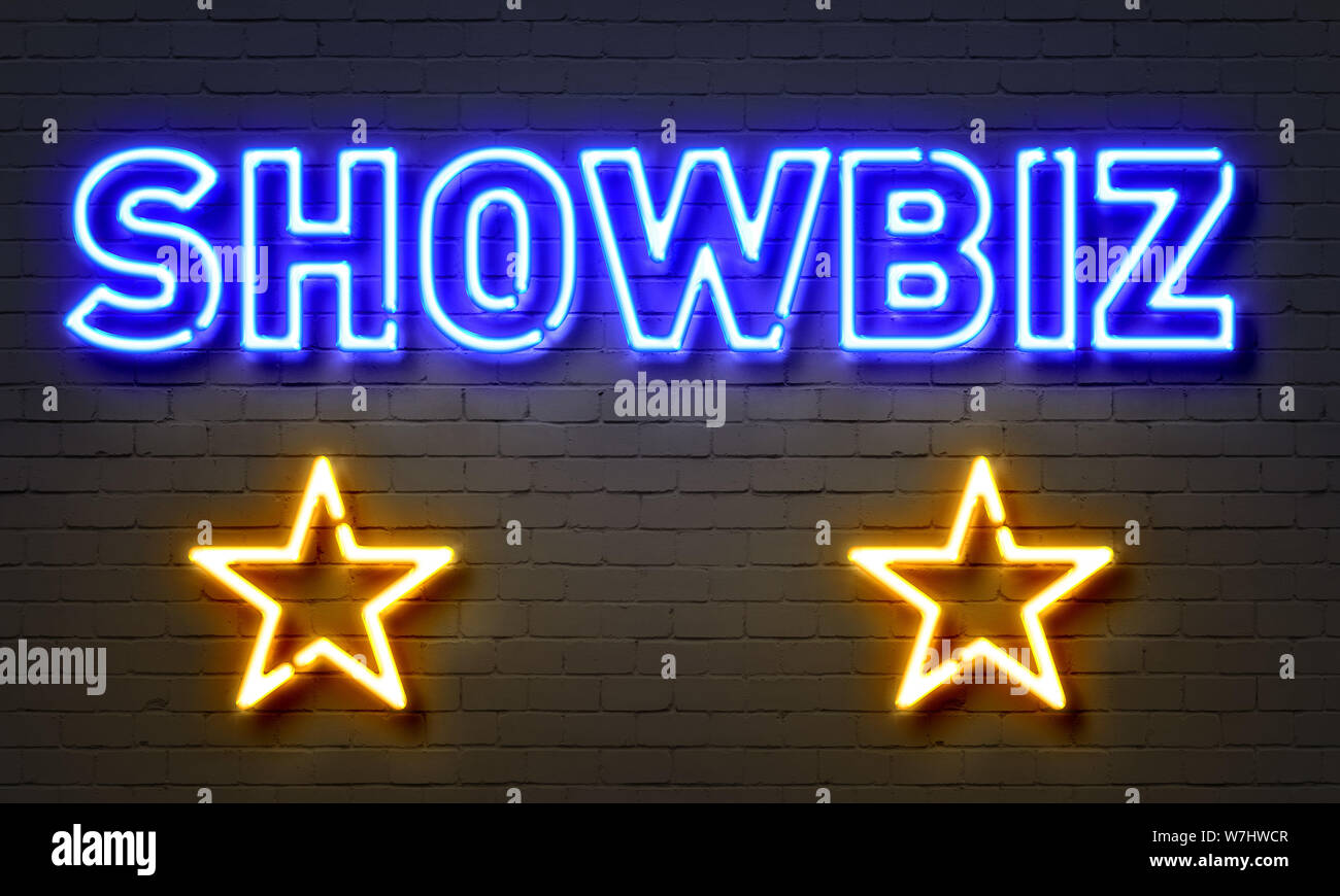 Showbiz neon sign on brick wall background Stock Photo - Alamy