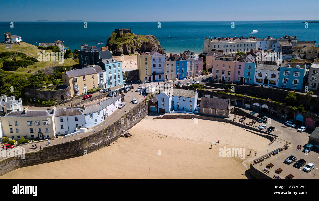Aerial drone view of colorful buildings next to the ocean in a ...