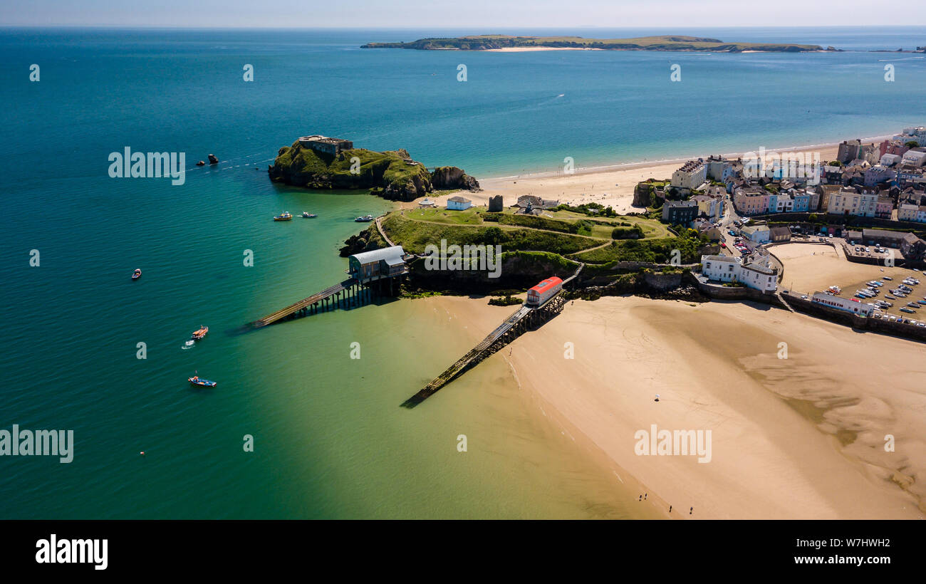 Aerial drone view of a beautiful coast town with sandy beaches and ...