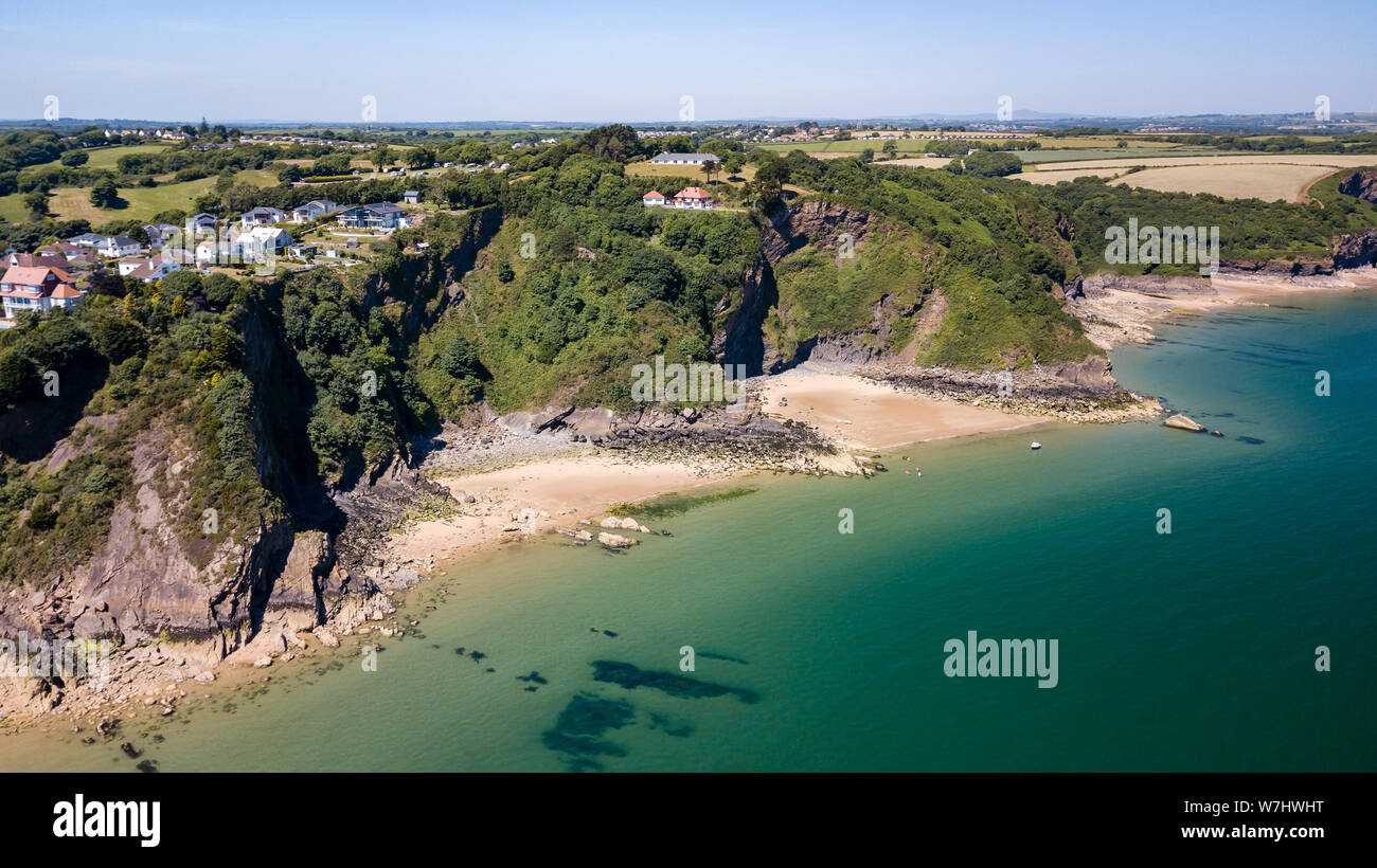 Aerial drone view of a beautiful coast town with sandy beaches and ...