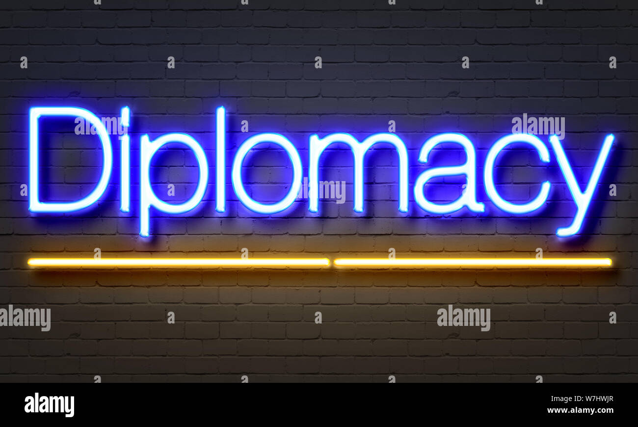 Diplomacy neon sign on brick wall background Stock Photo - Alamy