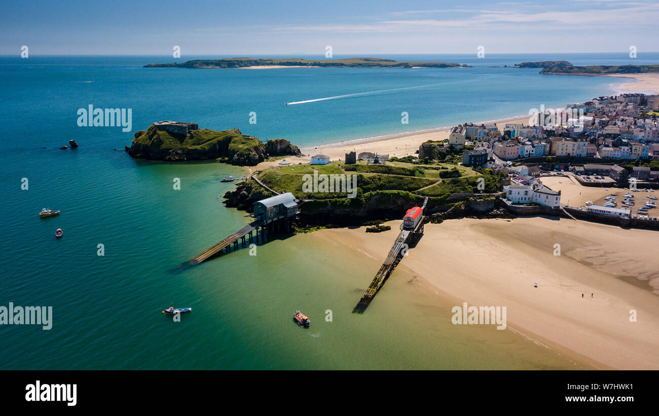 Aerial drone view of a beautiful coast town with sandy beaches and ...