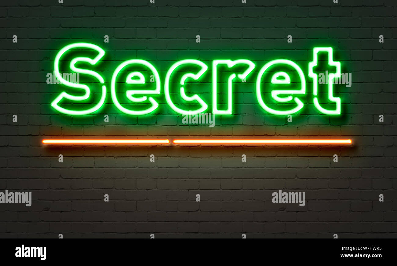 Secret neon sign on brick wall background Stock Photo - Alamy