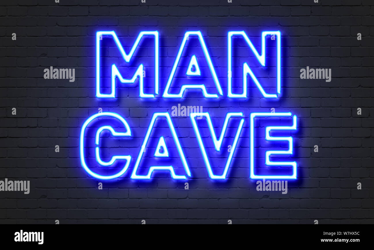 Man cave neon sign on brick wall background Stock Photo - Alamy