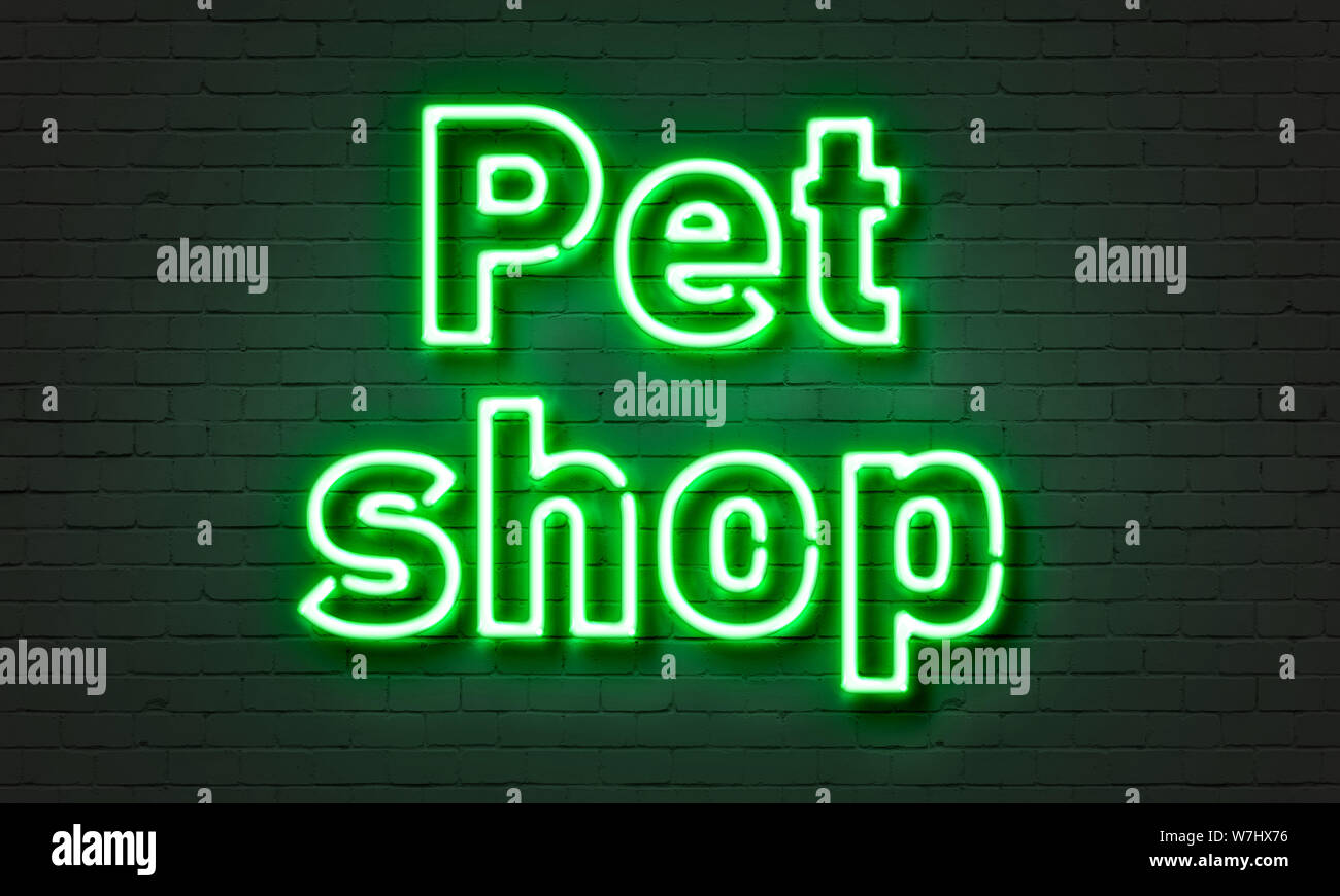 Pet shop neon sign on brick wall background Stock Photo - Alamy
