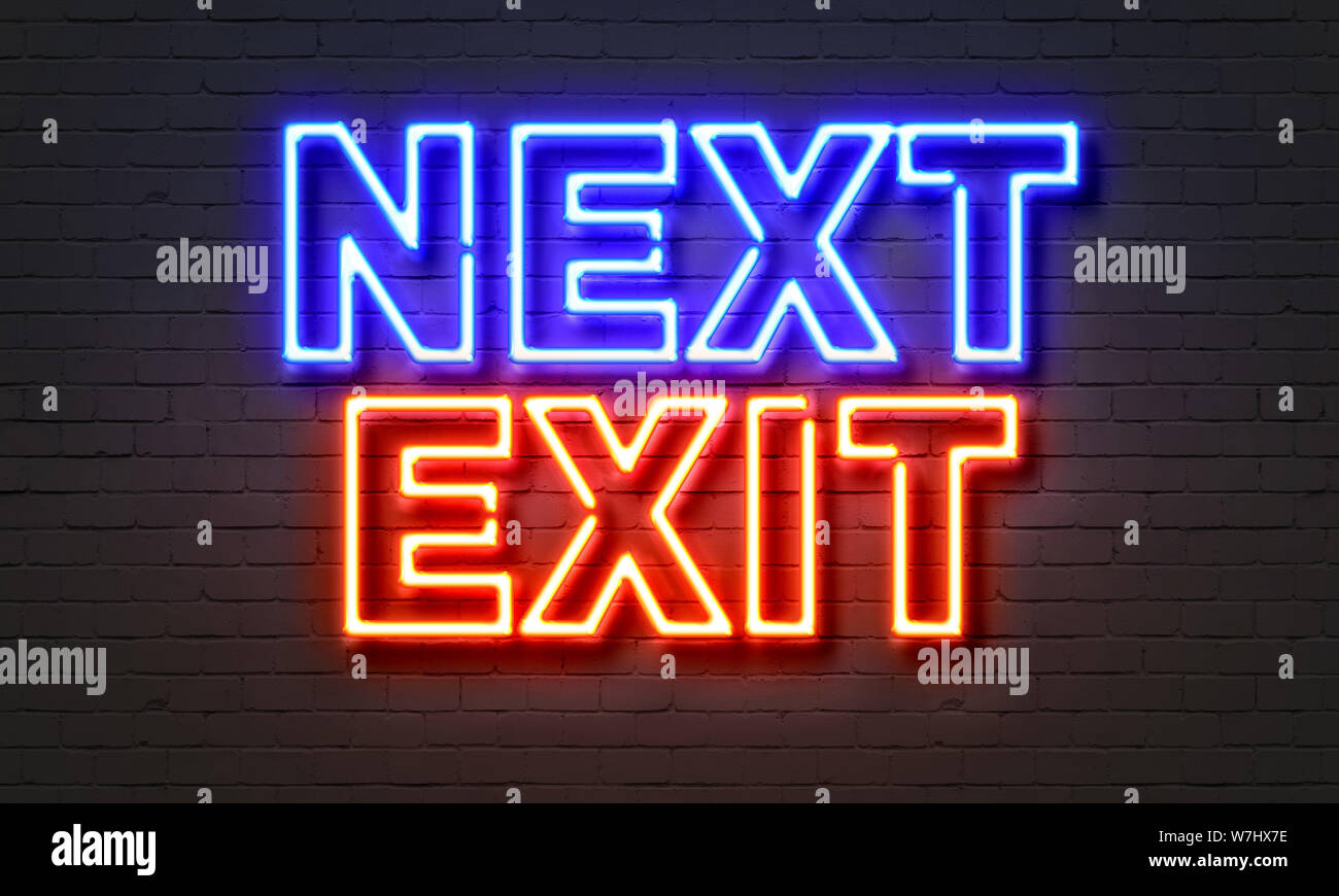 Next exit neon sign on brick wall background Stock Photo - Alamy