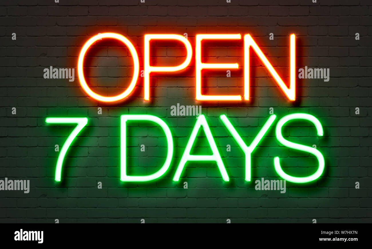 Open 7 days neon sign on brick wall background Stock Photo - Alamy