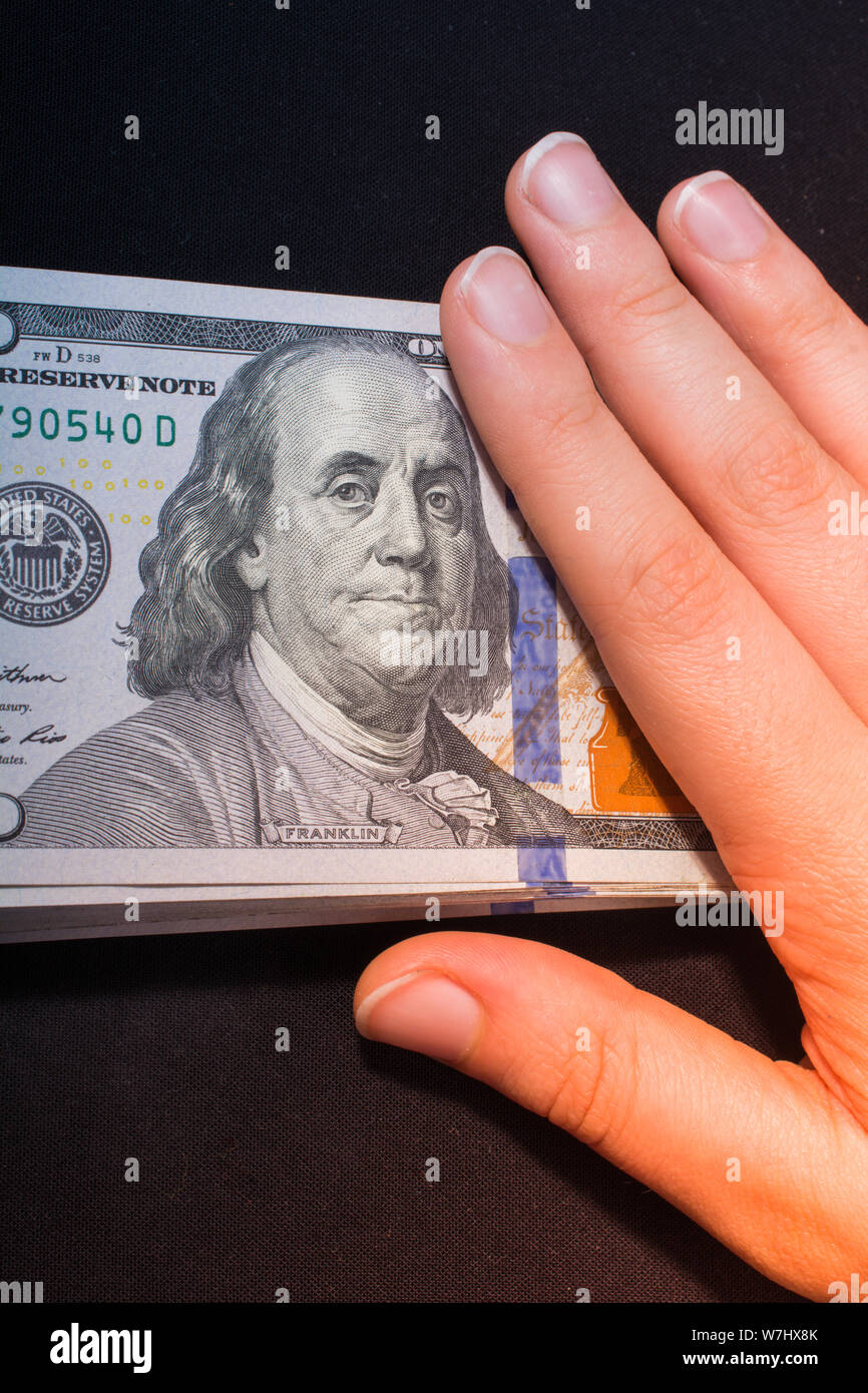 Hand holding American dollar banknotes isolated on white background ...