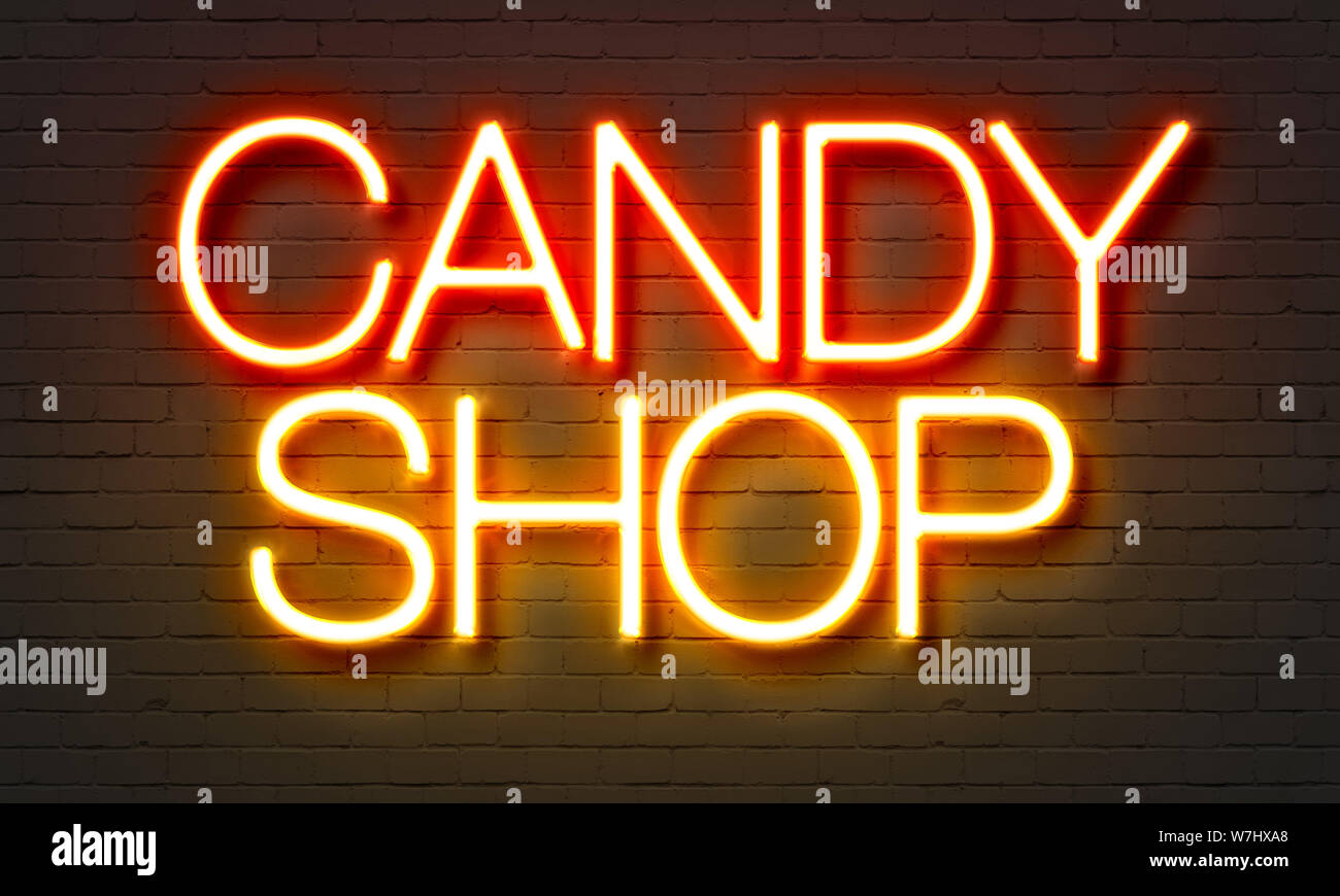 Candy shop neon sign on brick wall background Stock Photo - Alamy