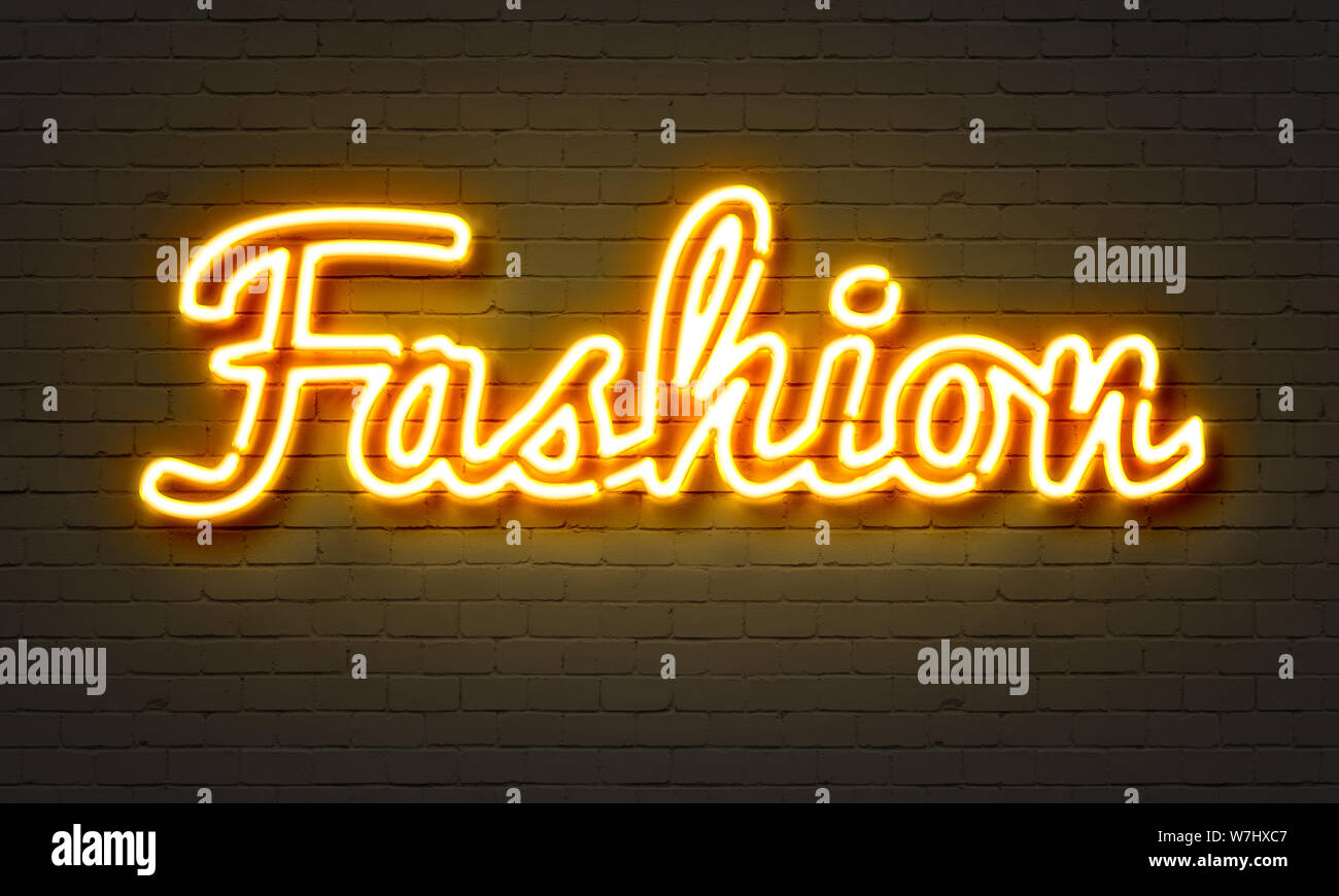 Fashion neon sign on brick wall background Stock Photo - Alamy