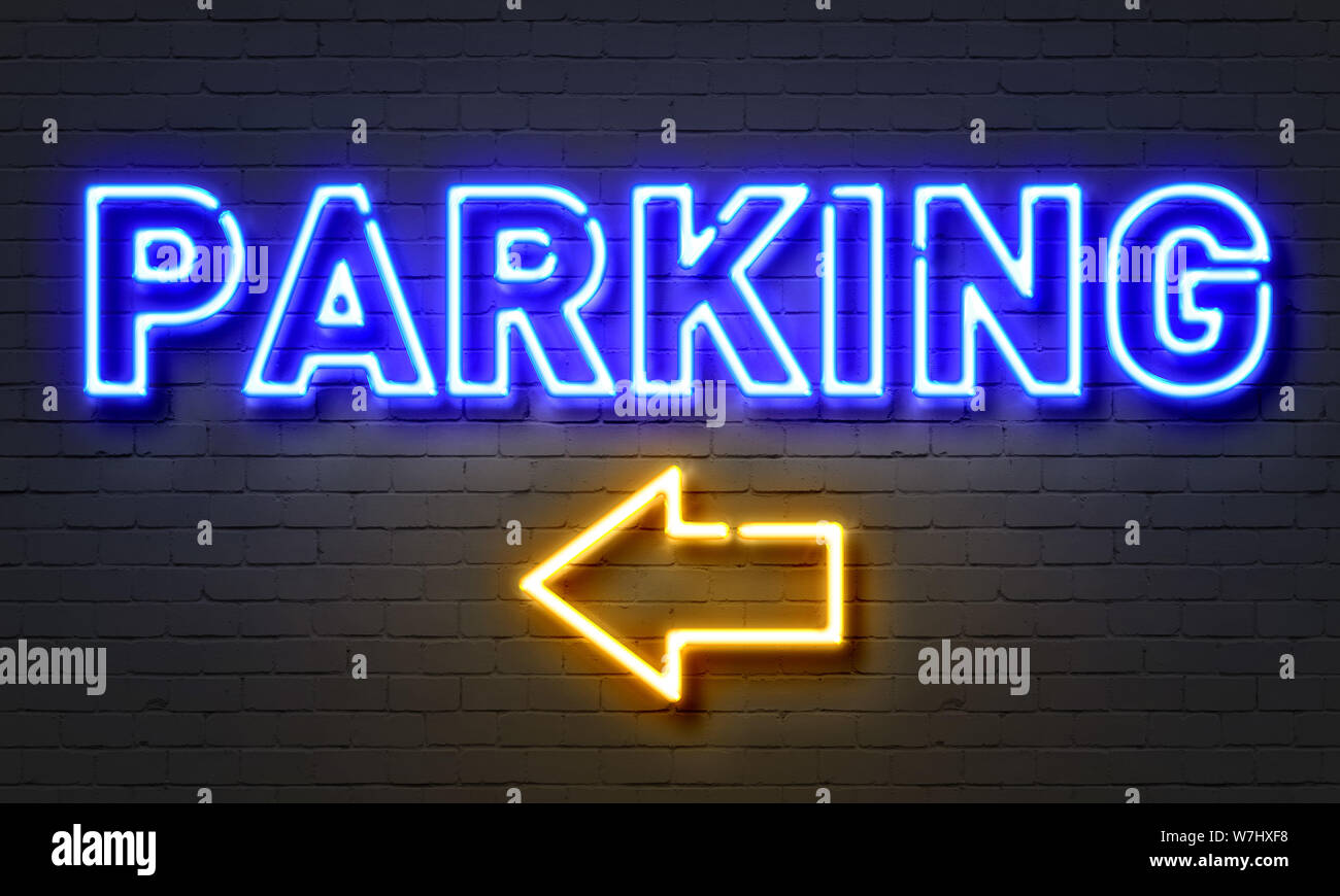 Parking neon sign on brick wall background Stock Photo - Alamy