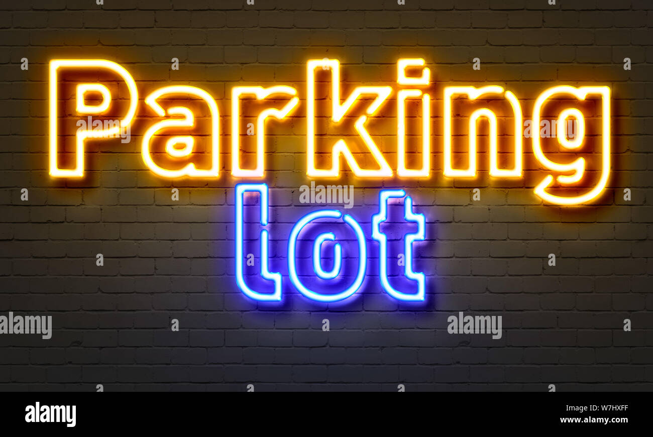 Parking lot neon sign on brick wall background Stock Photo - Alamy