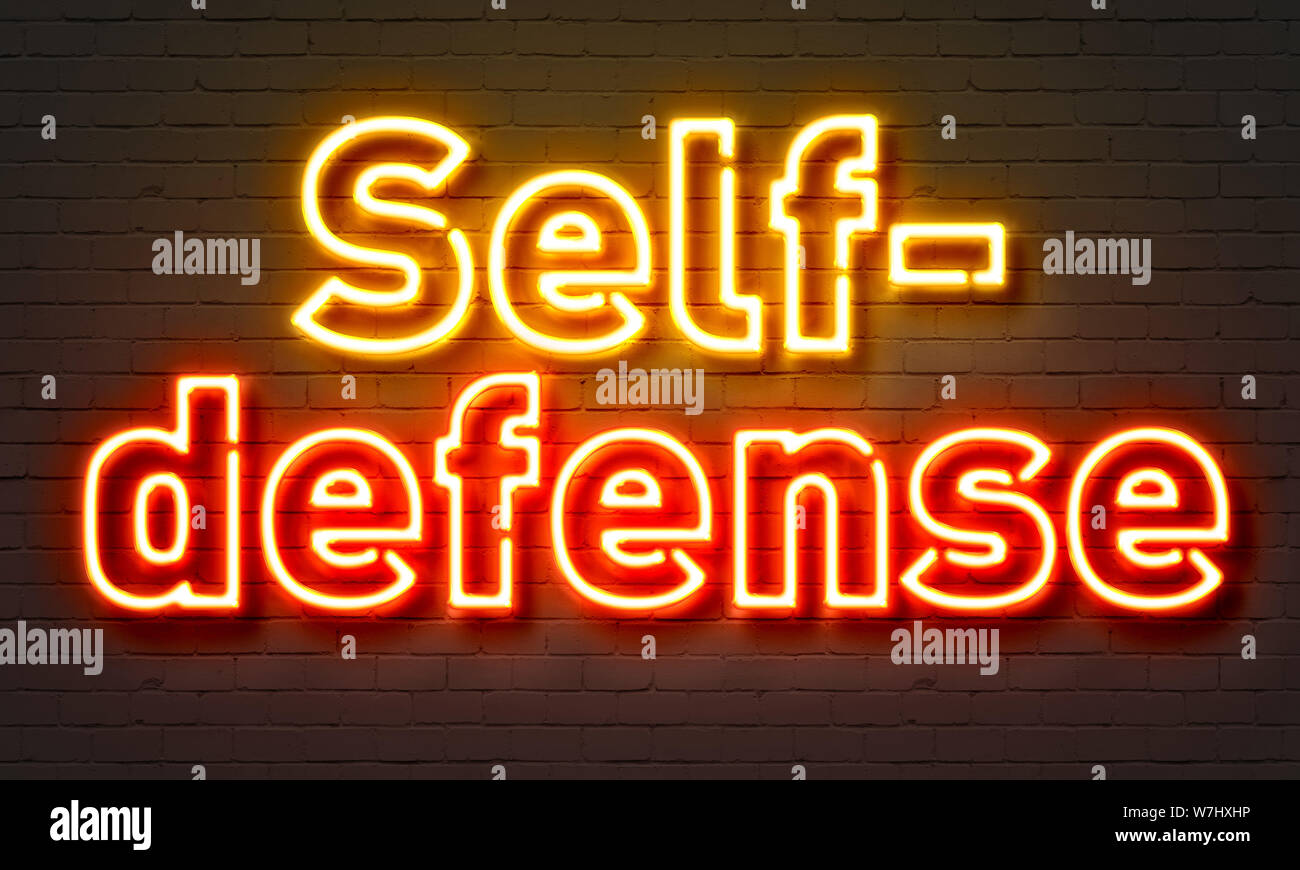 Self-defense neon sign on brick wall background Stock Photo - Alamy