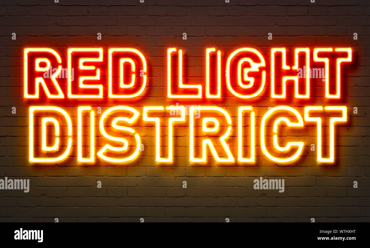 Red light district neon sign on brick wall background Stock Photo - Alamy
