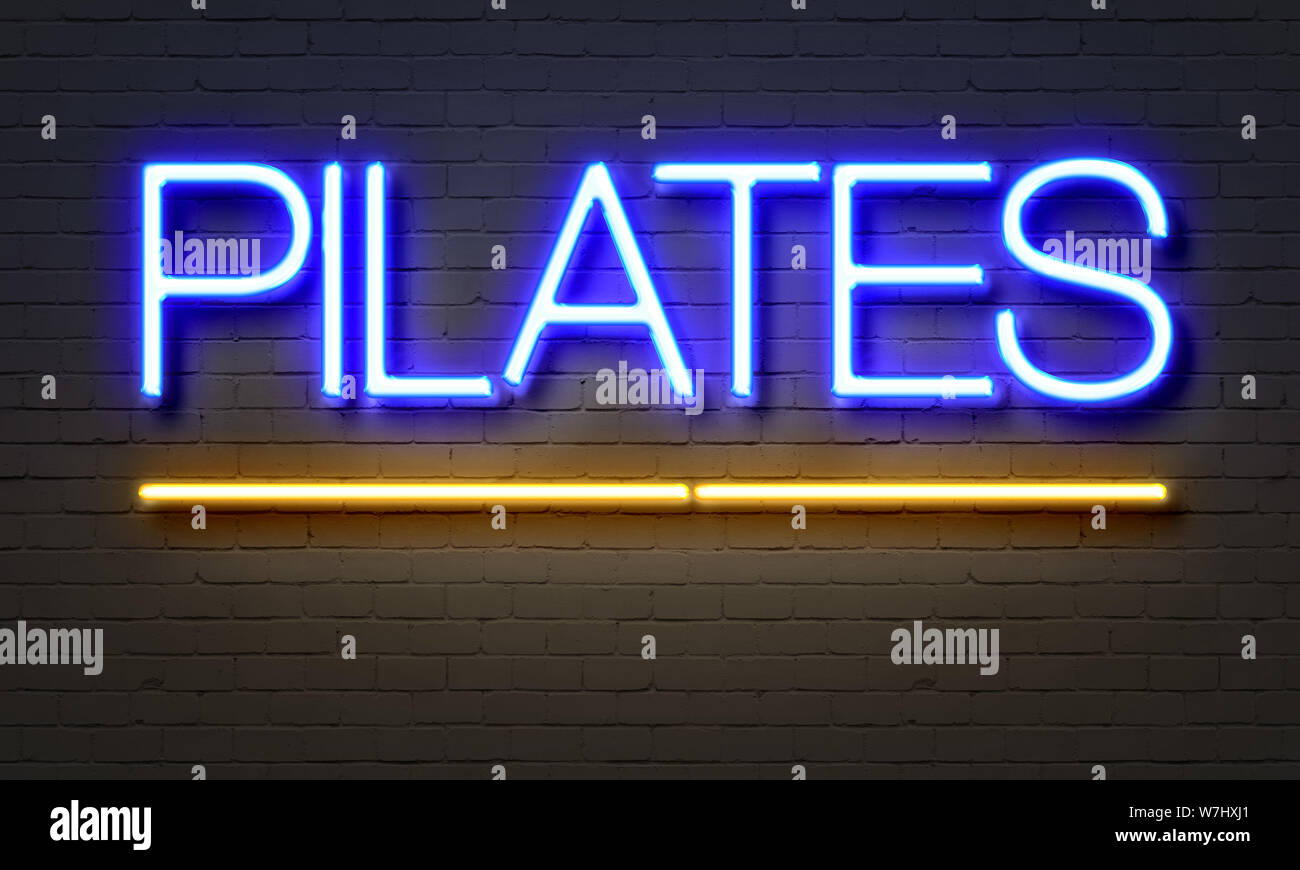Pilates neon sign on brick wall background Stock Photo - Alamy