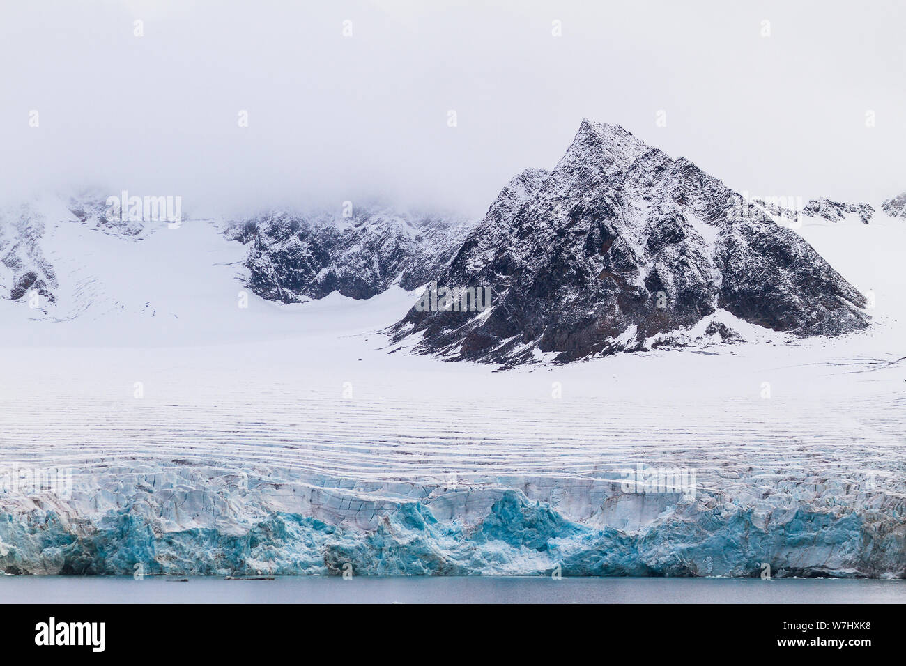Splintering glaciers wrap around a spiky Svalbard peak in ...