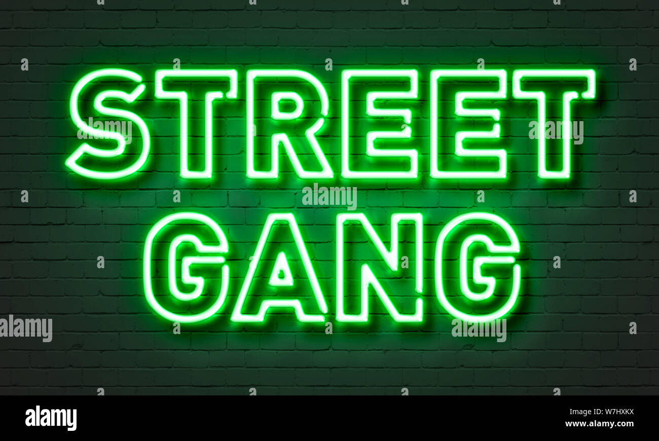 Street gang neon sign on brick wall background Stock Photo - Alamy