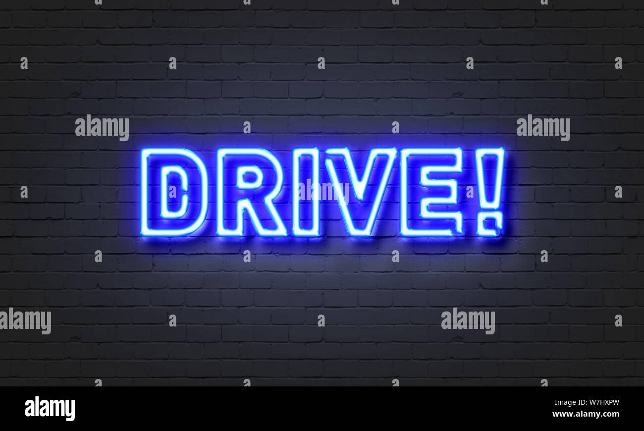 Drive neon sign on brick wall background Stock Photo - Alamy