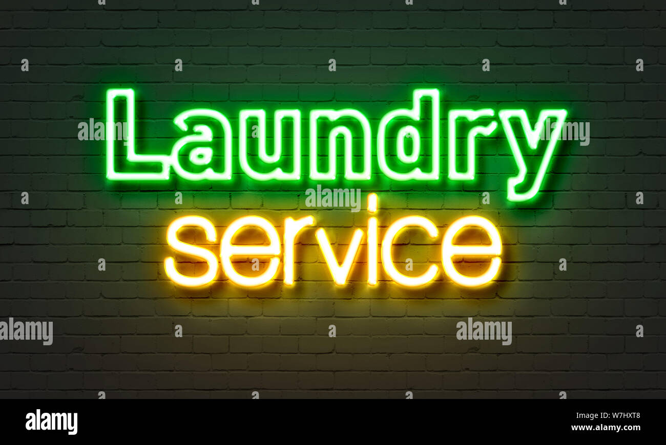 Laundry service neon sign on brick wall background Stock Photo - Alamy