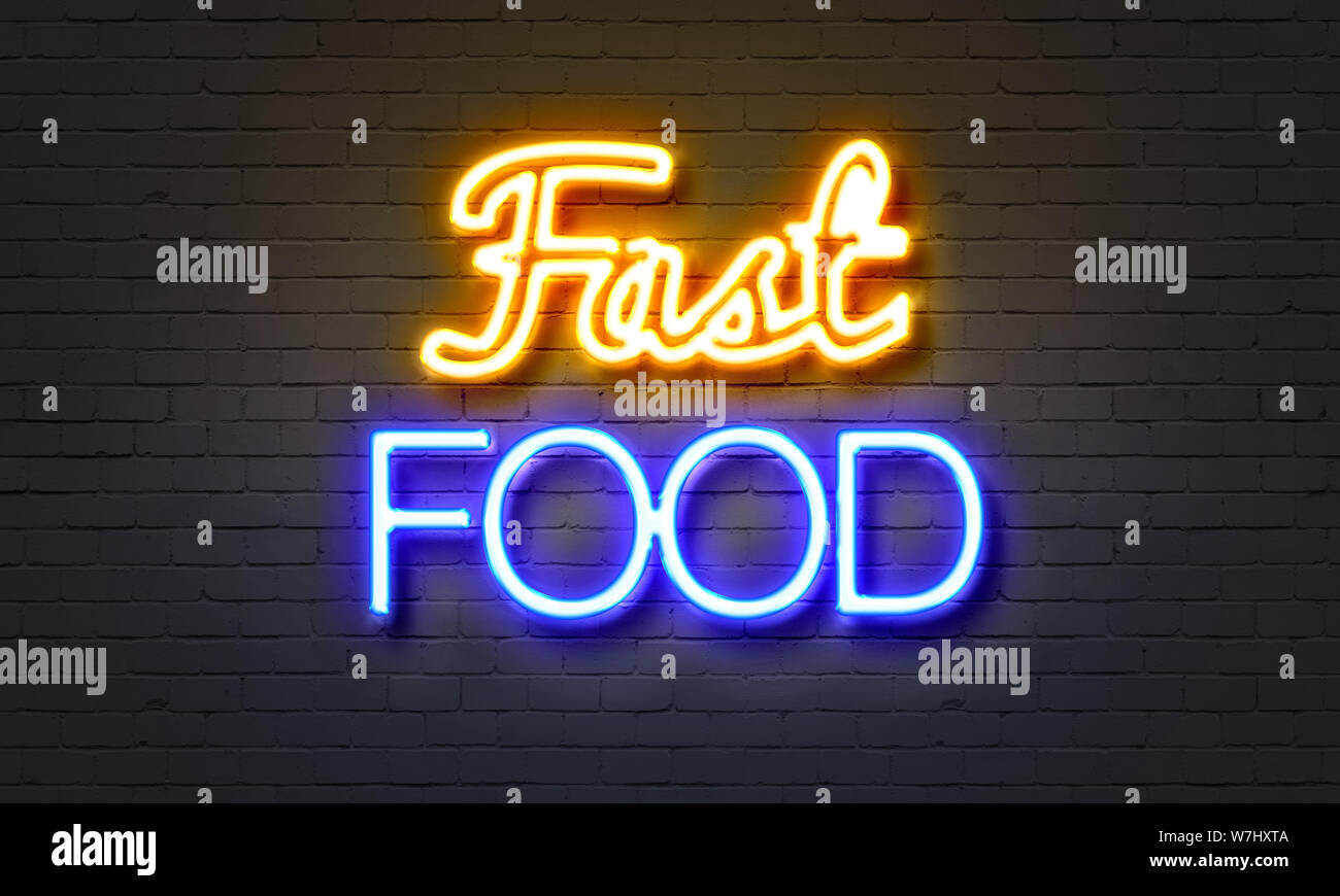 Fast food neon sign on brick wall background Stock Photo - Alamy