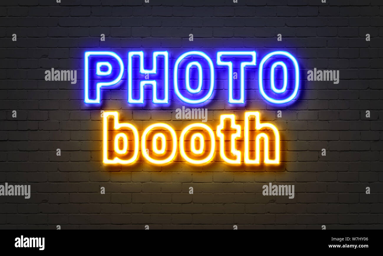 Photo booth neon sign on brick wall background Stock Photo - Alamy