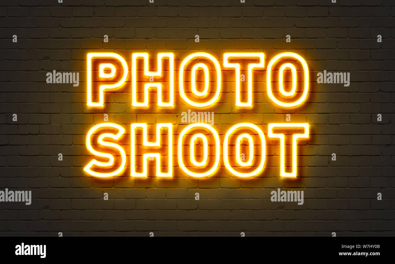 Photo shoot neon sign on brick wall background Stock Photo - Alamy