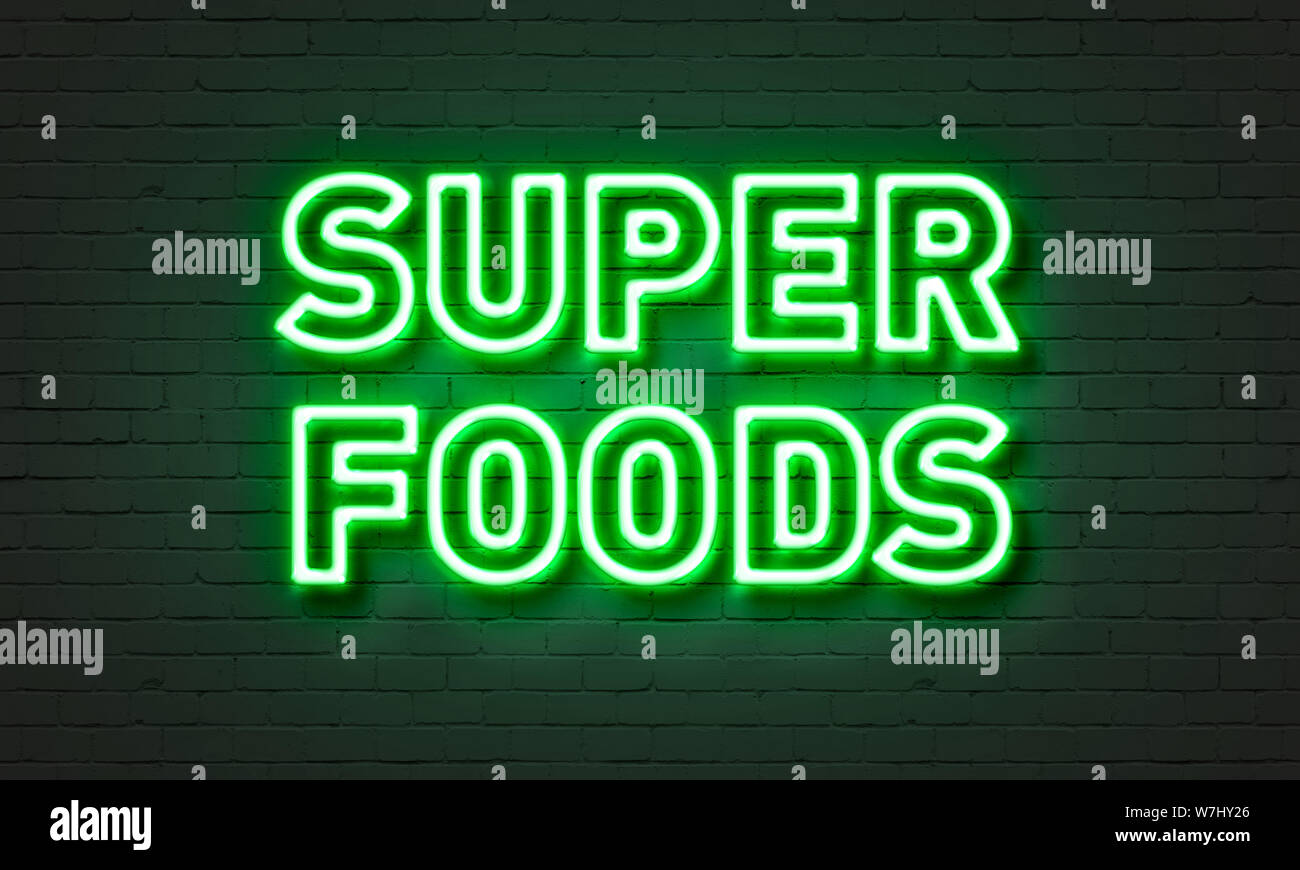 Super foods neon sign on brick wall background Stock Photo - Alamy